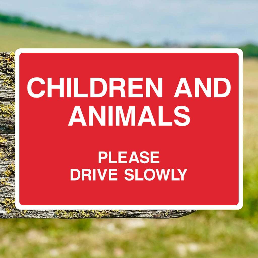 Children And Animals Please Drive Slowly Sign
